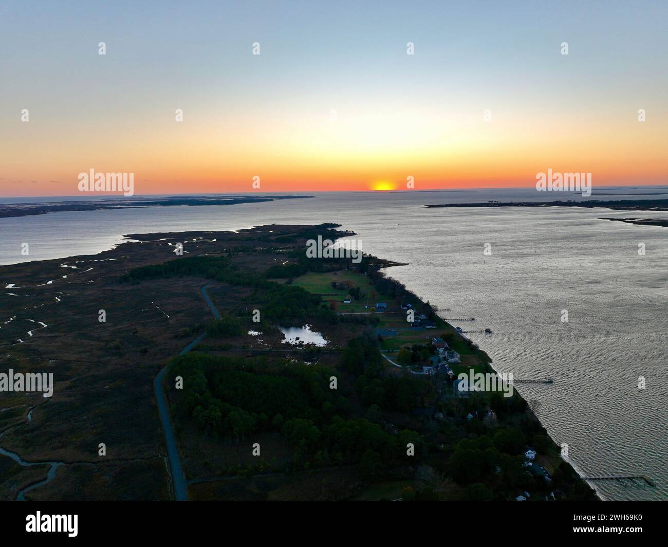 An aerial view of Mount Vernon, Maryland at golden sunset, casting a ...