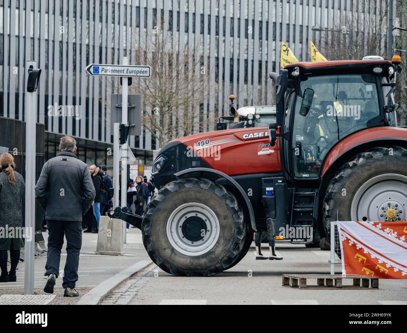 Strasbourg, France - Feb 6, 2024: Red tractor obstructs street entrance ...