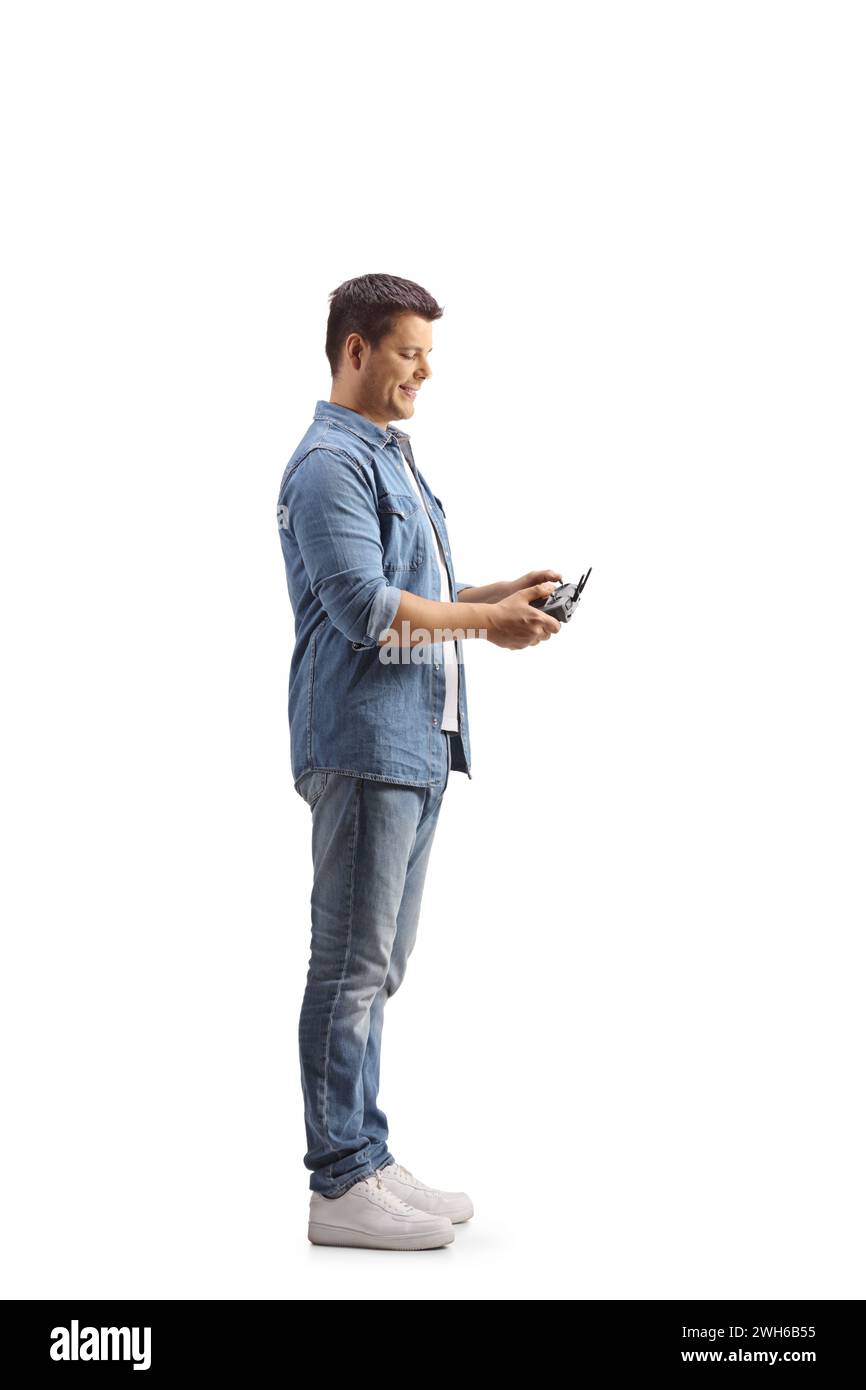 Man holding a remote controller for a drone isolated on white ...