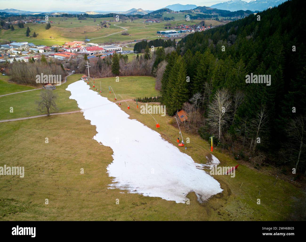 Alpine skiing on the ski slope in warm temperatures and lack of snow at ...