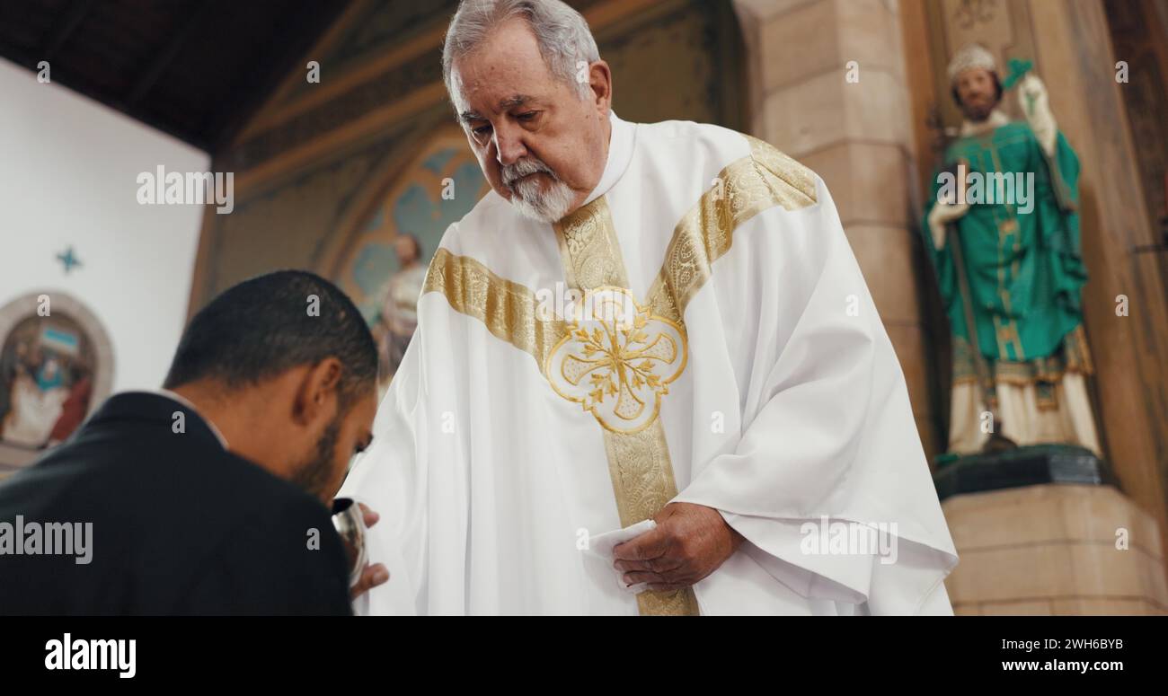Religion, church and man with priest for communion for ceremony ...