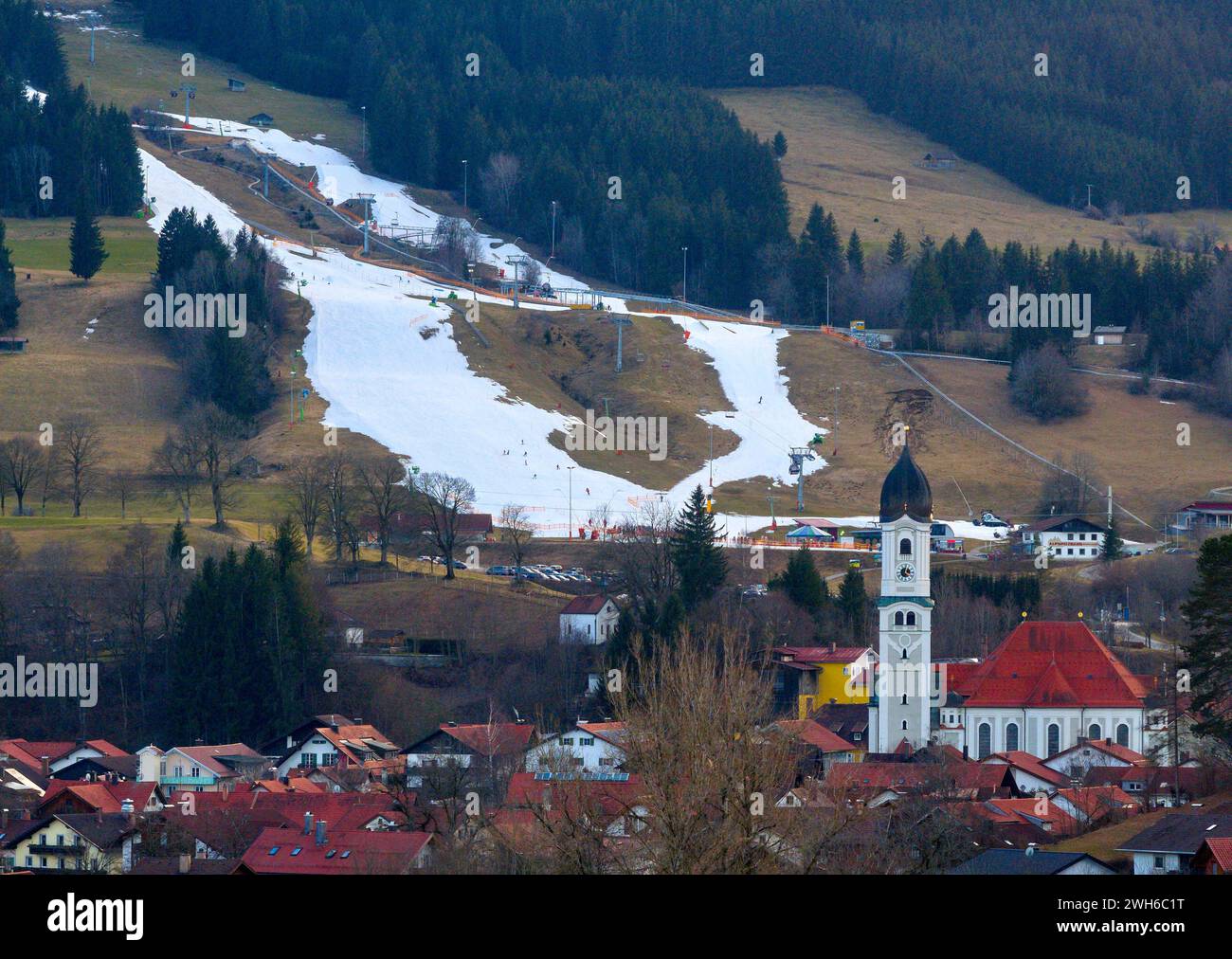 Alpine skiing on the ski slope in warm temperatures and lack of snow at ...