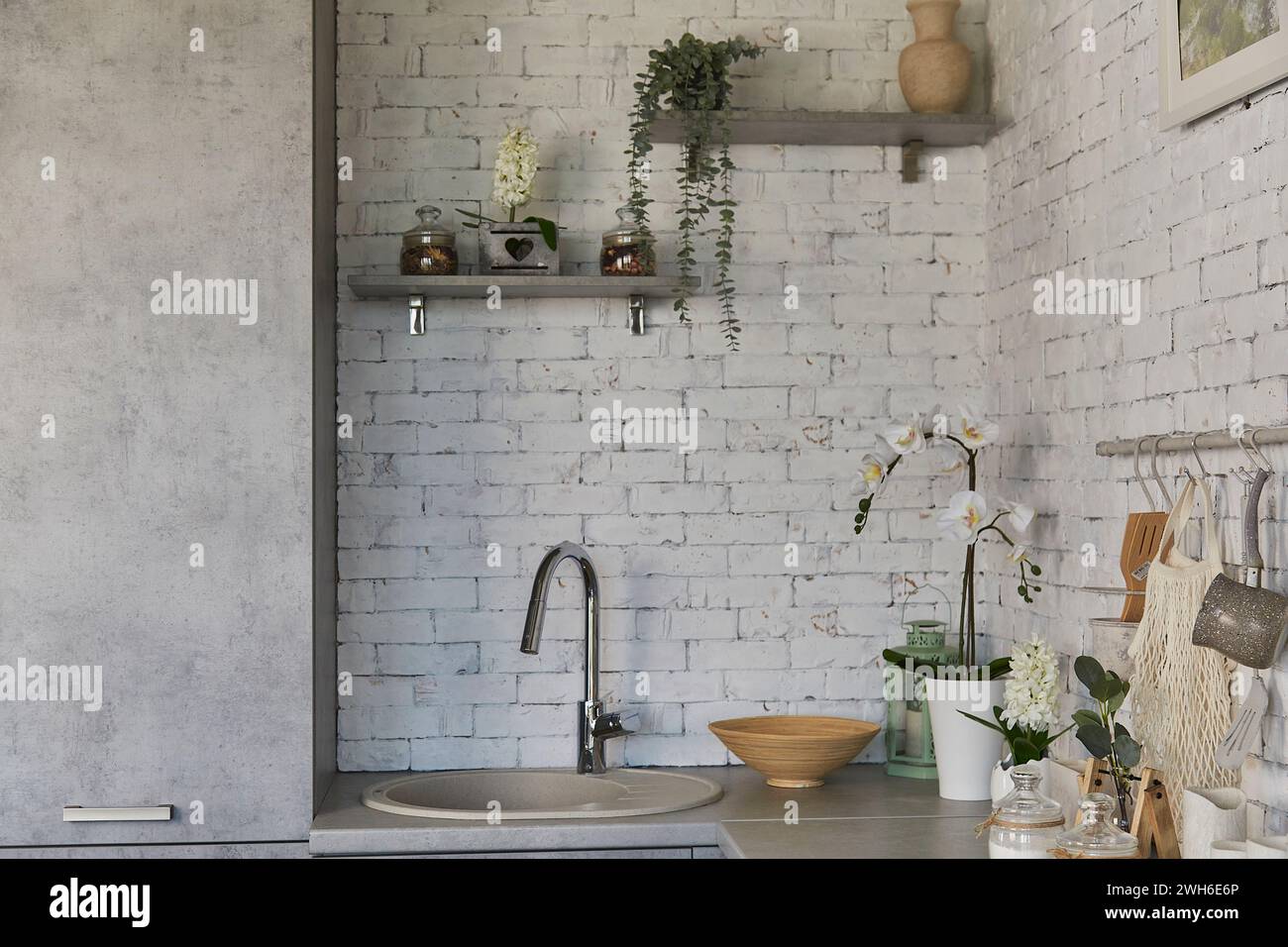 Urban chic kitchen corner with white brick wall, sink and natural ...