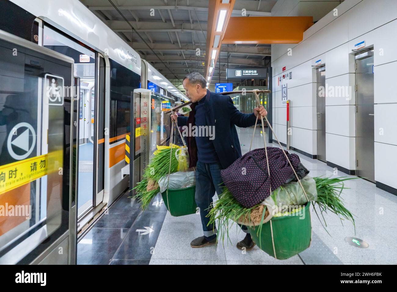 CHONGQING, CHINA - FEBRUARY 8, 2024 - Vegetable farmers carries baskets ...