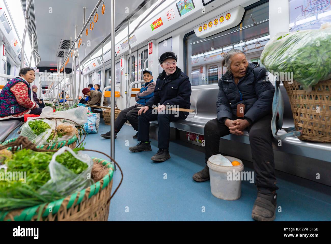 CHONGQING, CHINA - FEBRUARY 8, 2024 - Vegetable farmers carries baskets ...