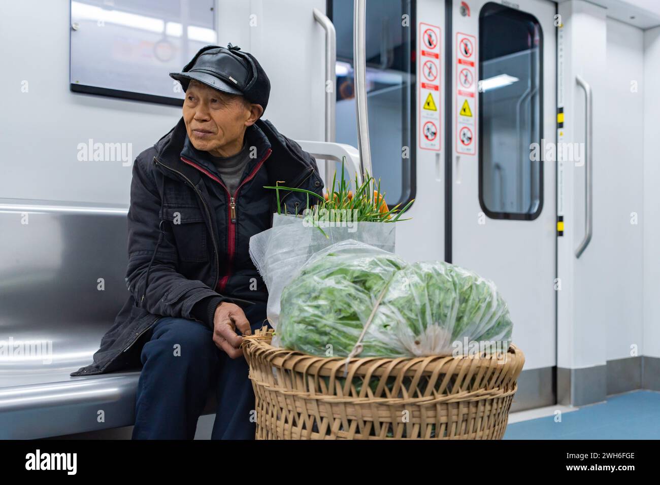 CHONGQING, CHINA - FEBRUARY 8, 2024 - Vegetable farmers carries baskets ...