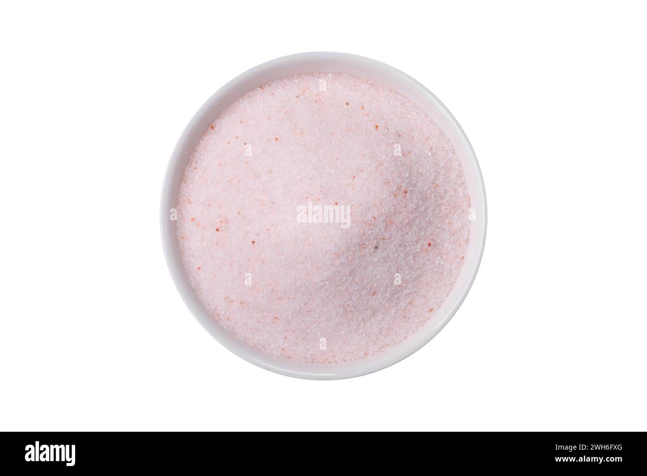 Fine pink Himalayan table salt in a ceramic bowl on a dark concrete ...