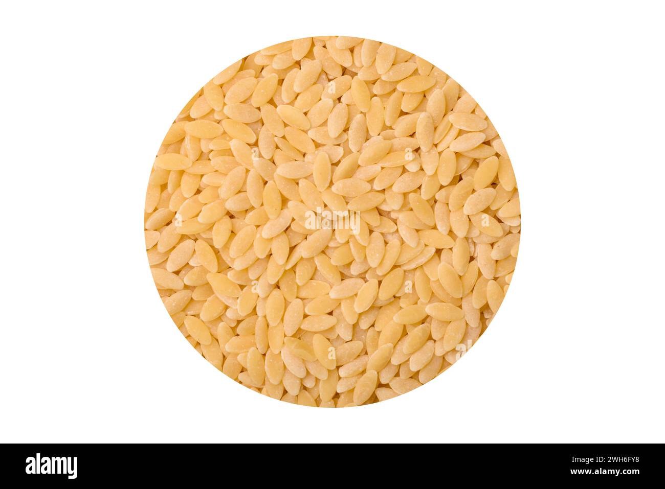 Raw risoni pasta made from durum wheat on a dark concrete background ...