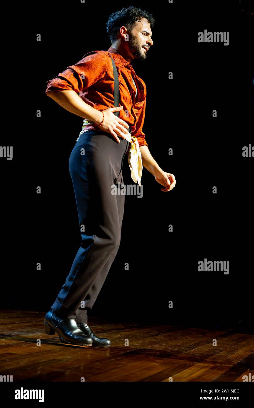 "Flamenco dancer in a vivid orange shirt embodies the spirit of the ...