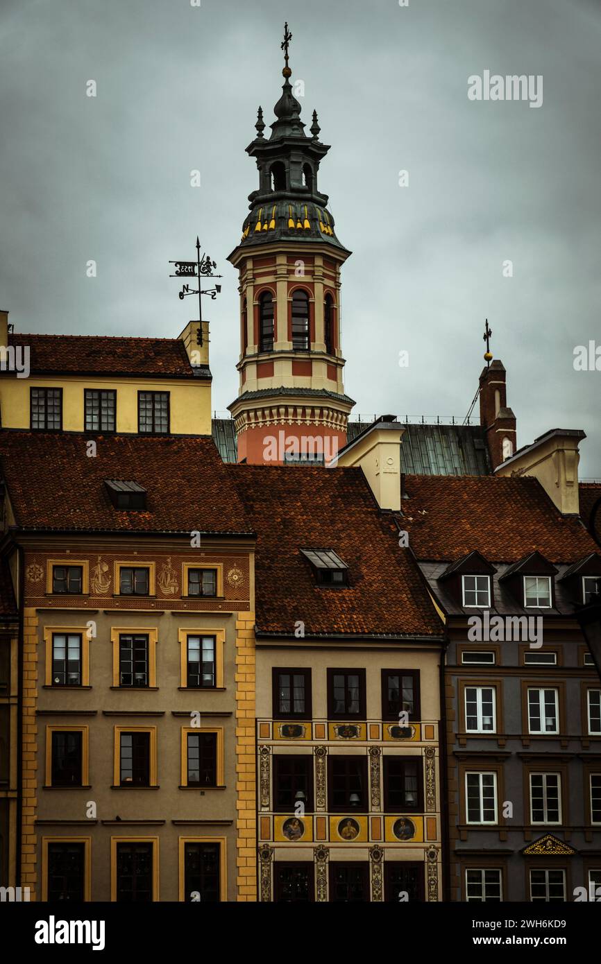 Tall tower amidst urban buildings against a sky backdrop Stock Photo ...