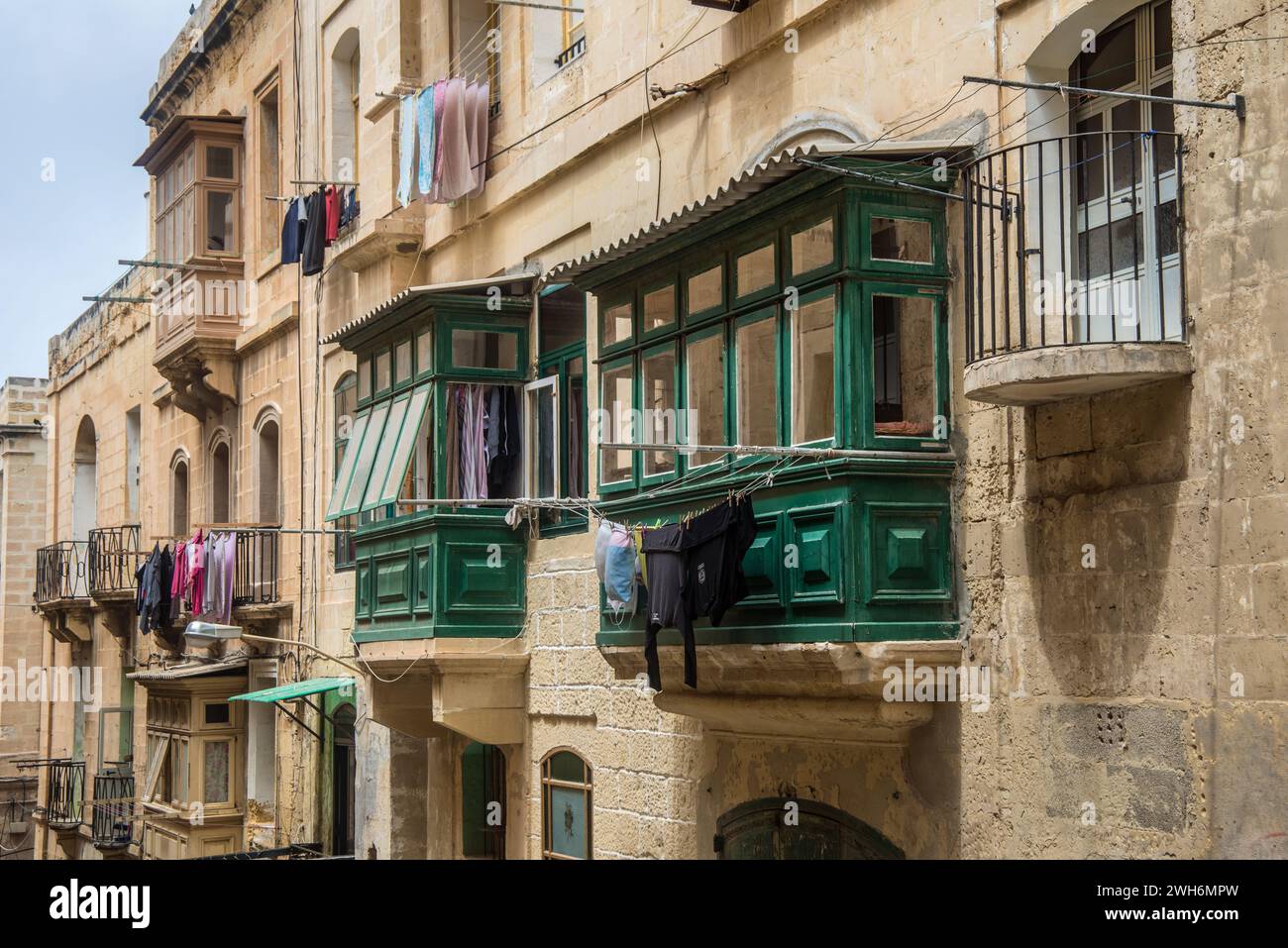 Washing hanging out to dry outside the windows of a building in ...