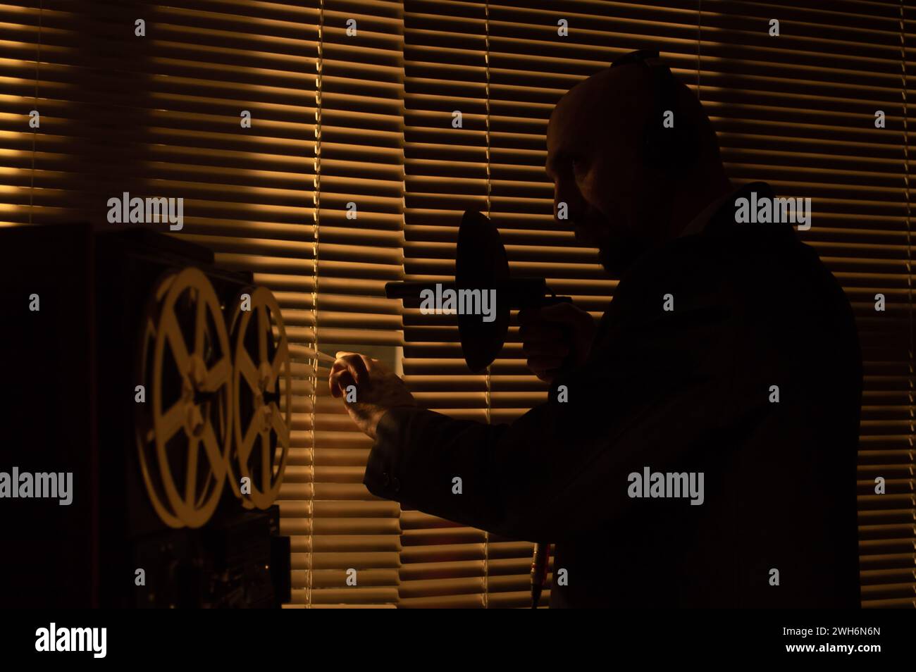 Secret agent secretly eavesdropping directional microphone pushing the ...