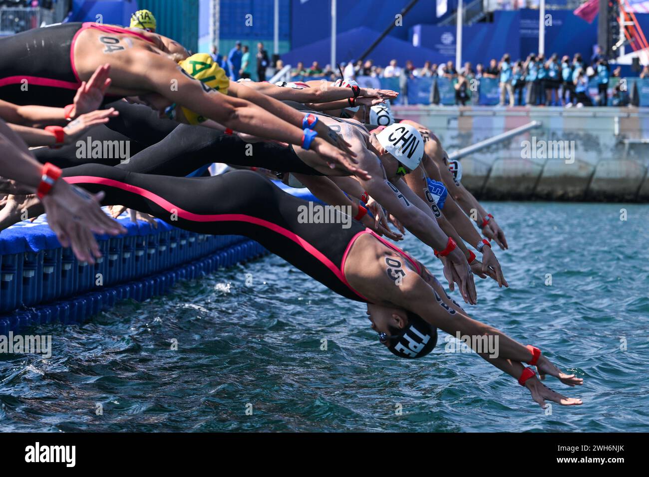 Doha, Qatar. 8th Feb, 2024. Swimmers jump into water during the mixed ...
