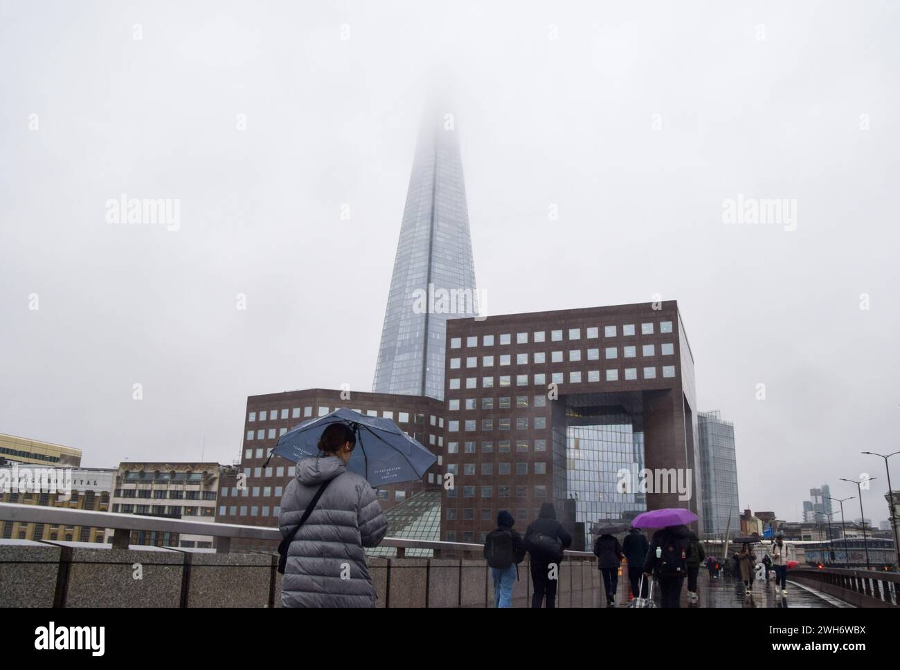 London, England, UK. 8th Feb, 2024. People walk across London Bridge ...
