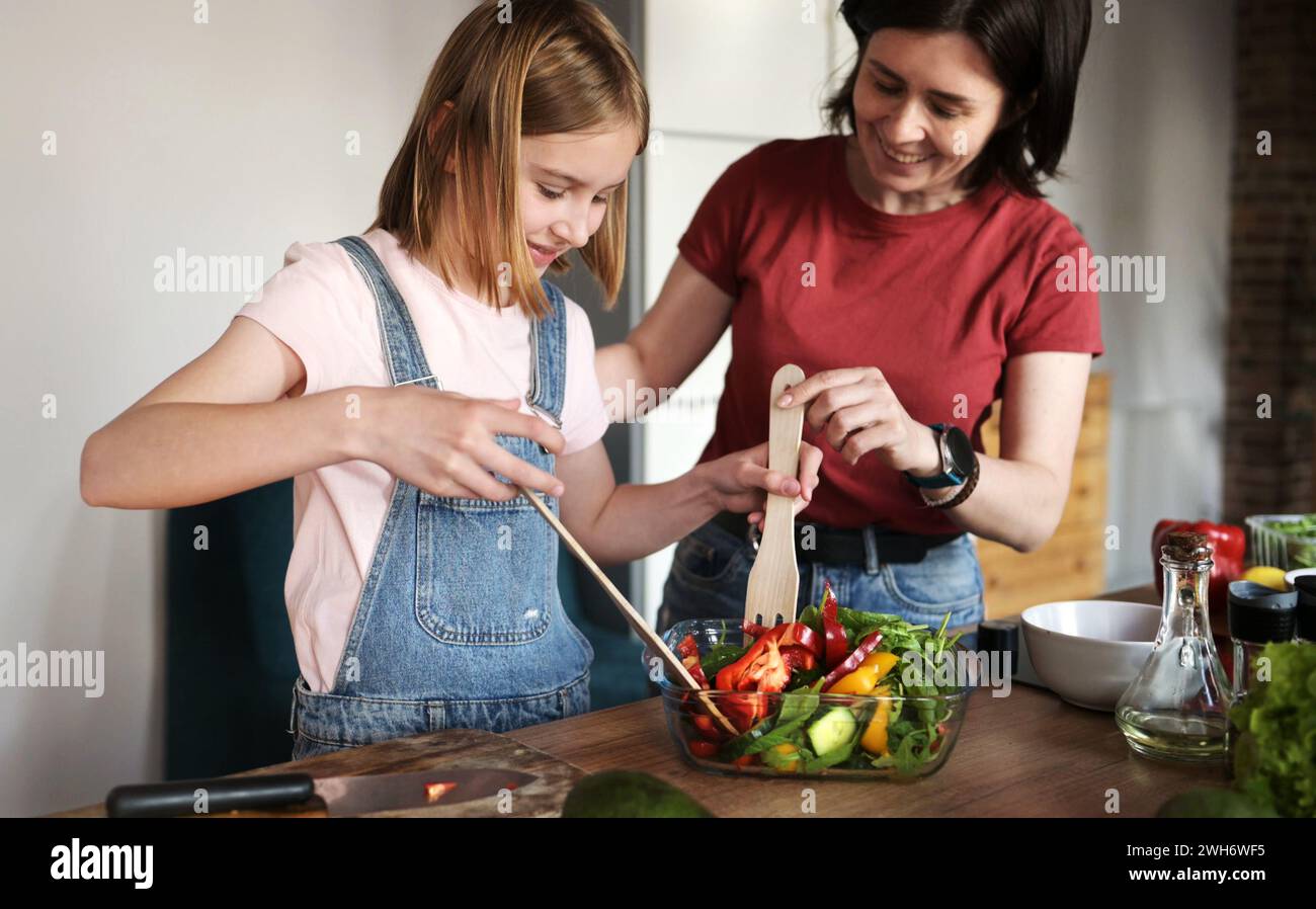 Beautiful Little Girl With Her Mother Cooking A Healthy Fresh Vegetable ...