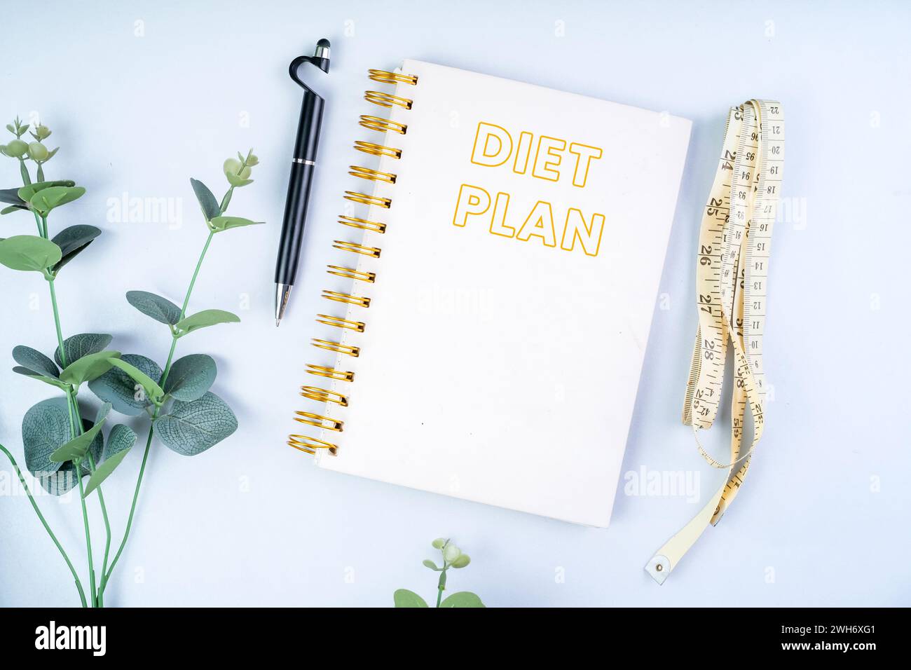Notebook with pen and measuring tape on white background, diet and ...