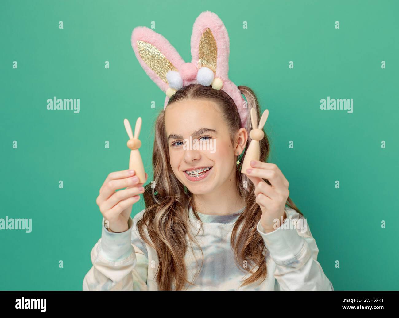 Happy Easter. Girl with joyful smile, wearing glittery pink bunny ears ...