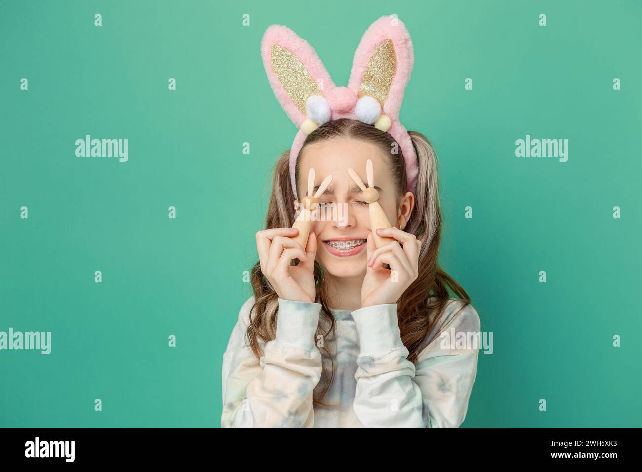 Happy Easter. Girl with joyful smile, wearing glittery pink bunny ears ...