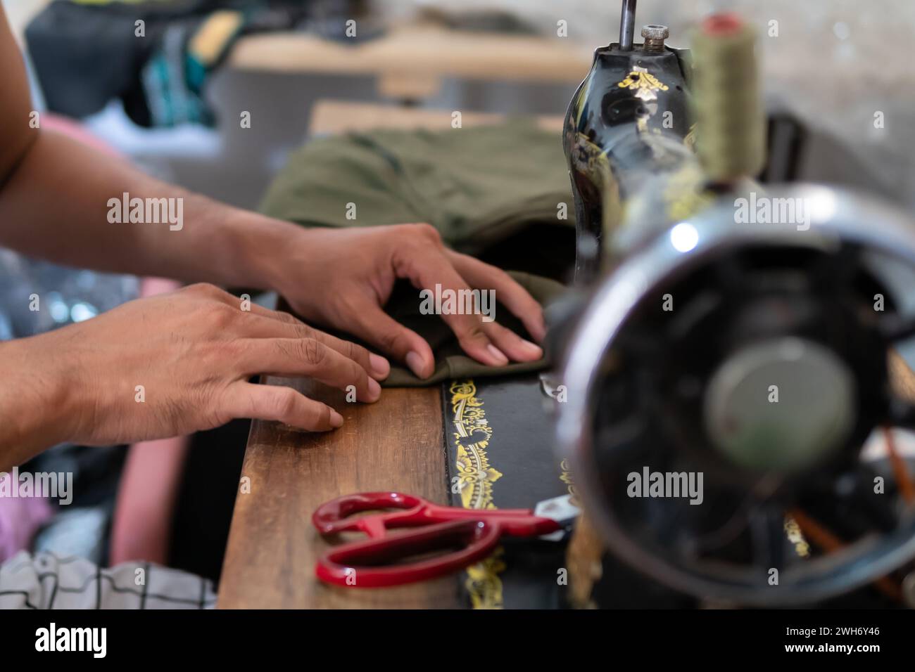 The tailor uses an old sewing machine Stock Photo - Alamy