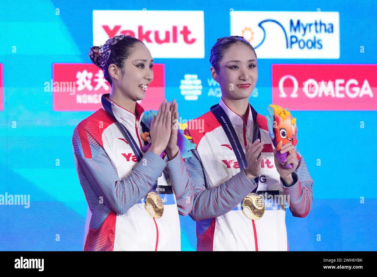 Gold medalists Wang Liuyi and Wang Qianyi, of China, react during the ...