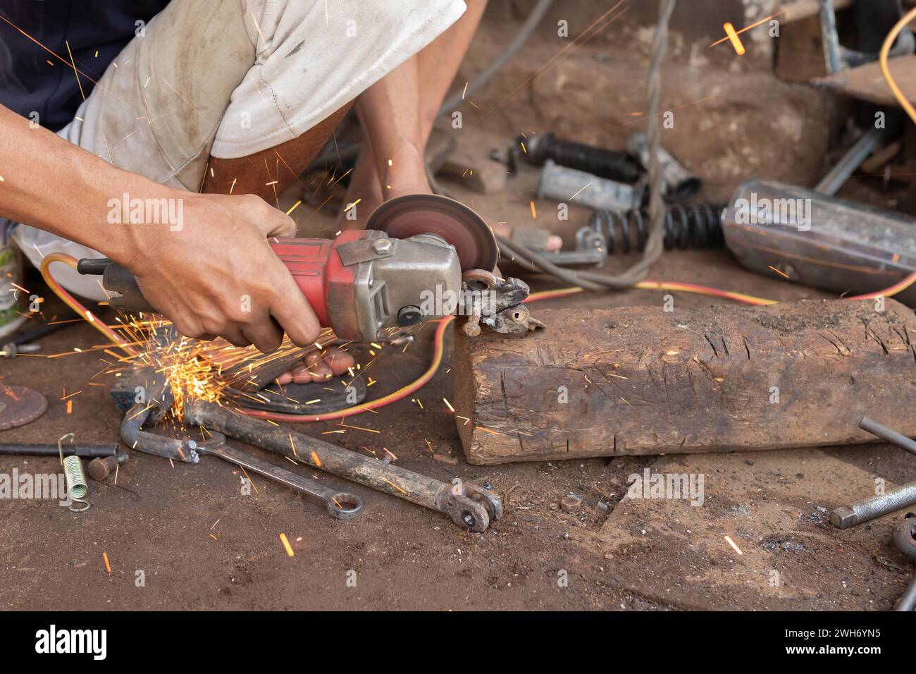 A welder cutting metal with a grinder prepares to weld Stock Photo - Alamy