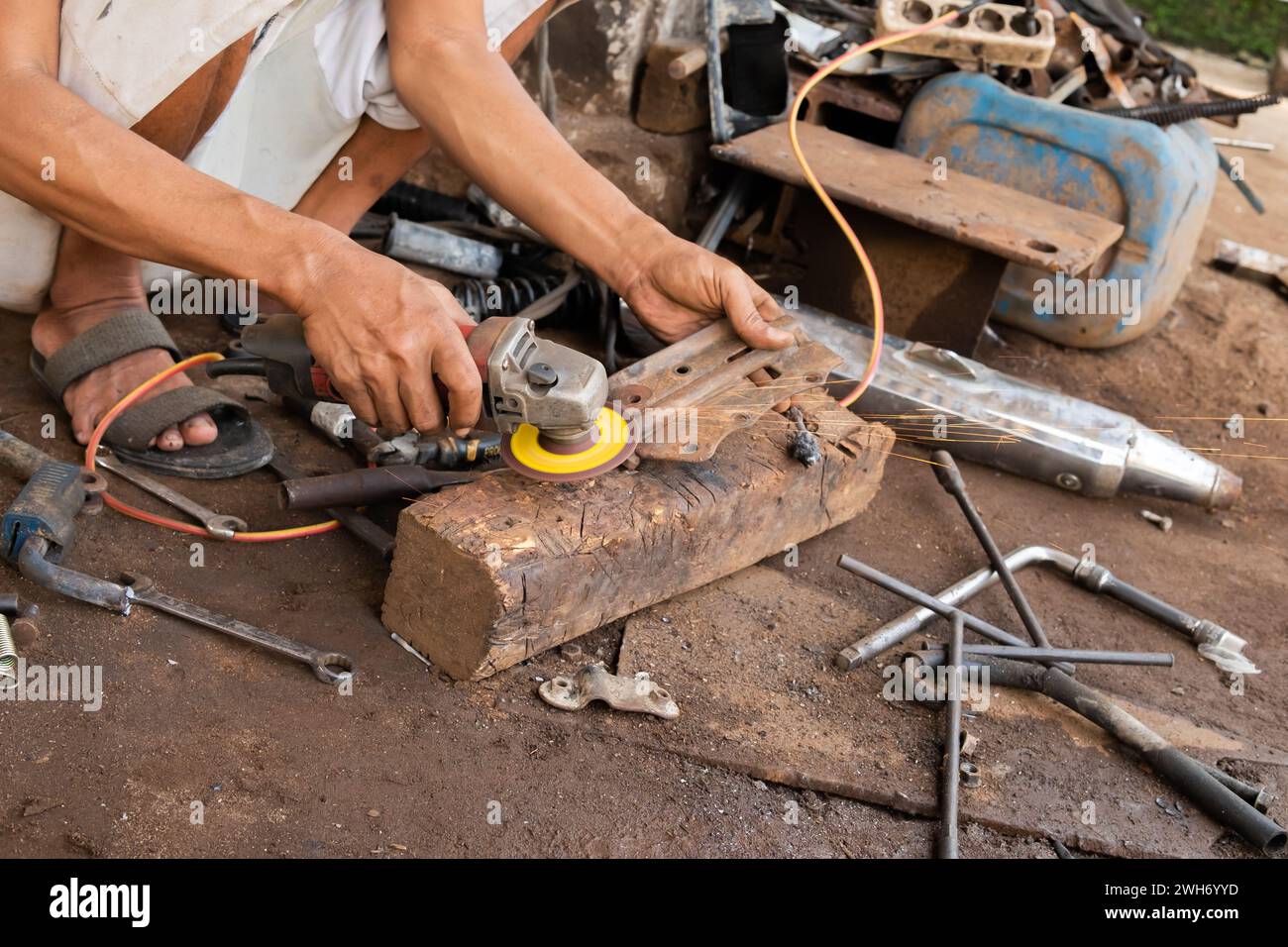 A welder cutting metal with a grinder prepares to weld Stock Photo - Alamy