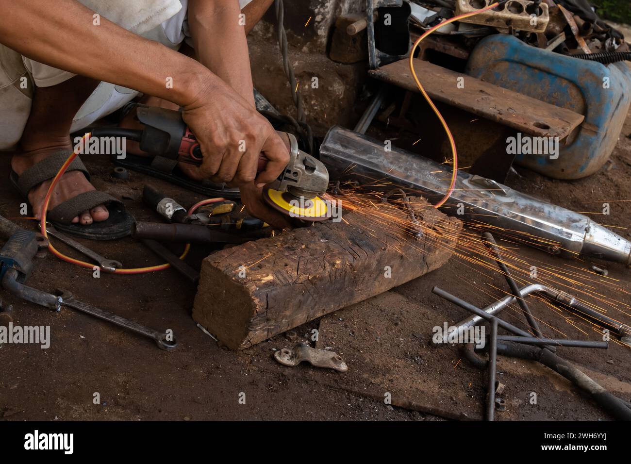 A welder cutting metal with a grinder prepares to weld Stock Photo - Alamy