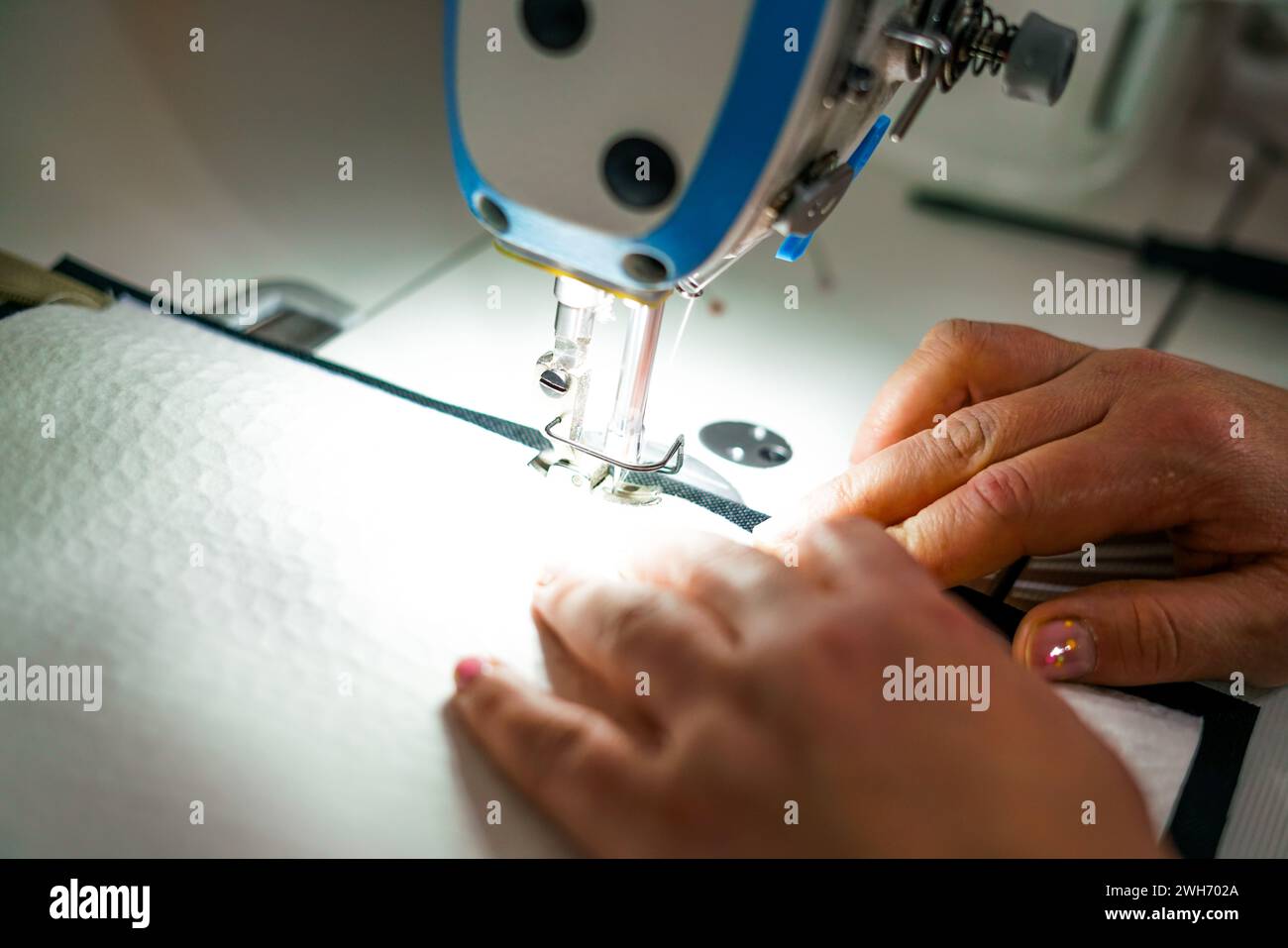 Working in the sewing studio. Sewing machine Stock Photo - Alamy