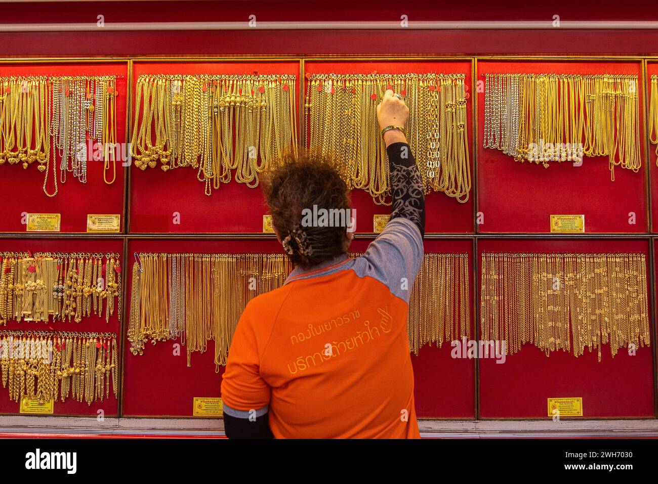 A gold seller seen prepares gold for sale at the gold shop in Chinatown ...