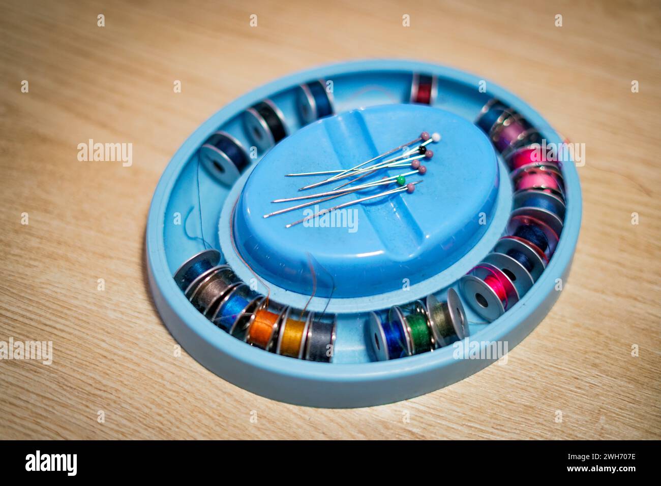 Colorful threads and pins in the sewing studio Stock Photo - Alamy