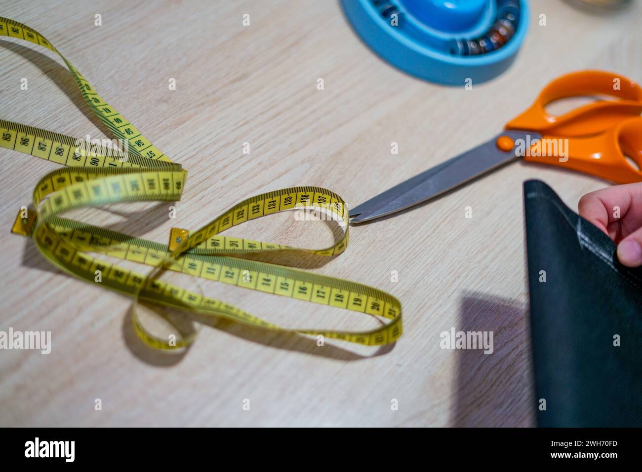 Measuring tape and scissors in the tailor shop Stock Photo - Alamy