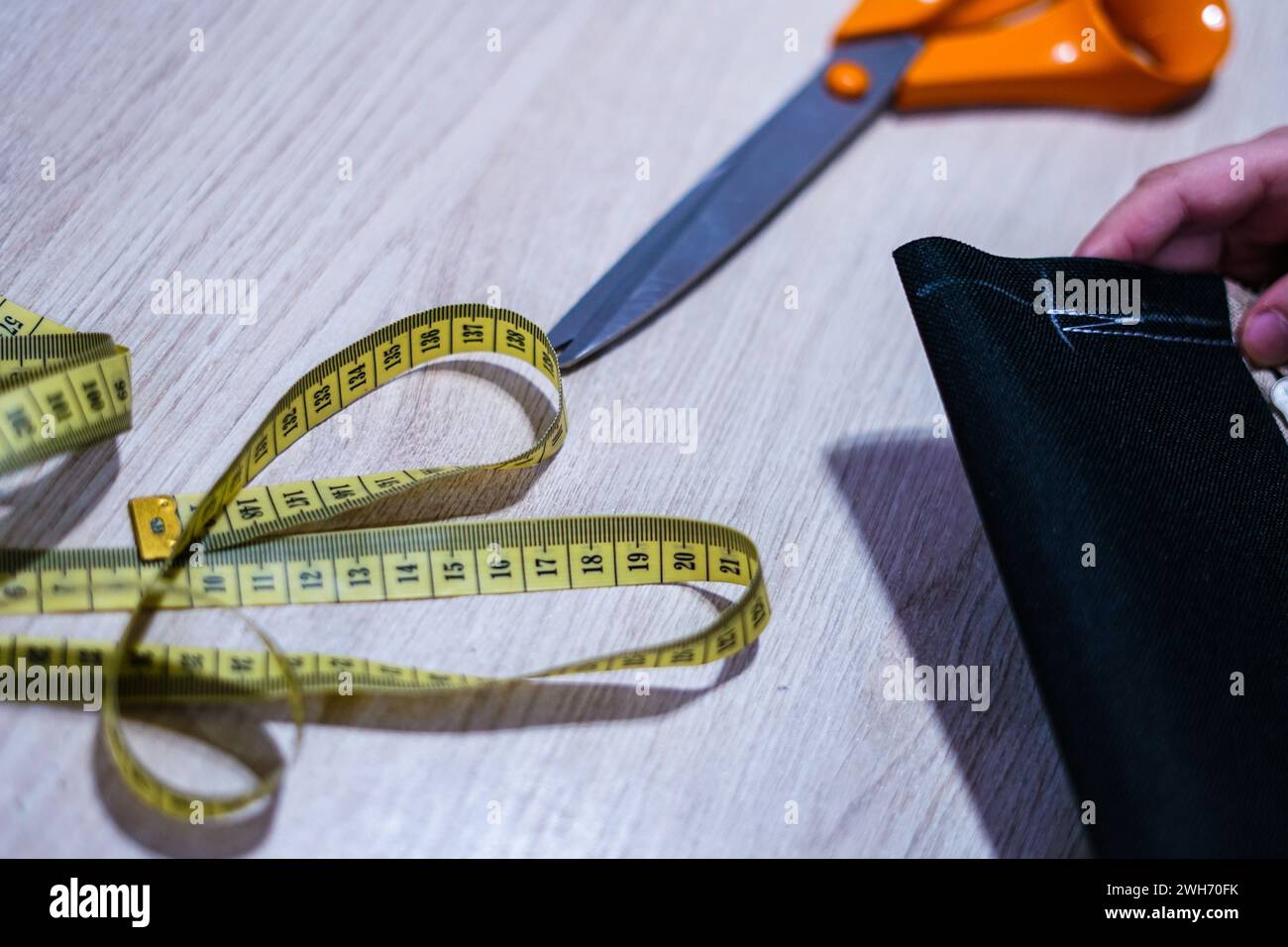 Measuring tape and scissors in the tailor shop Stock Photo - Alamy