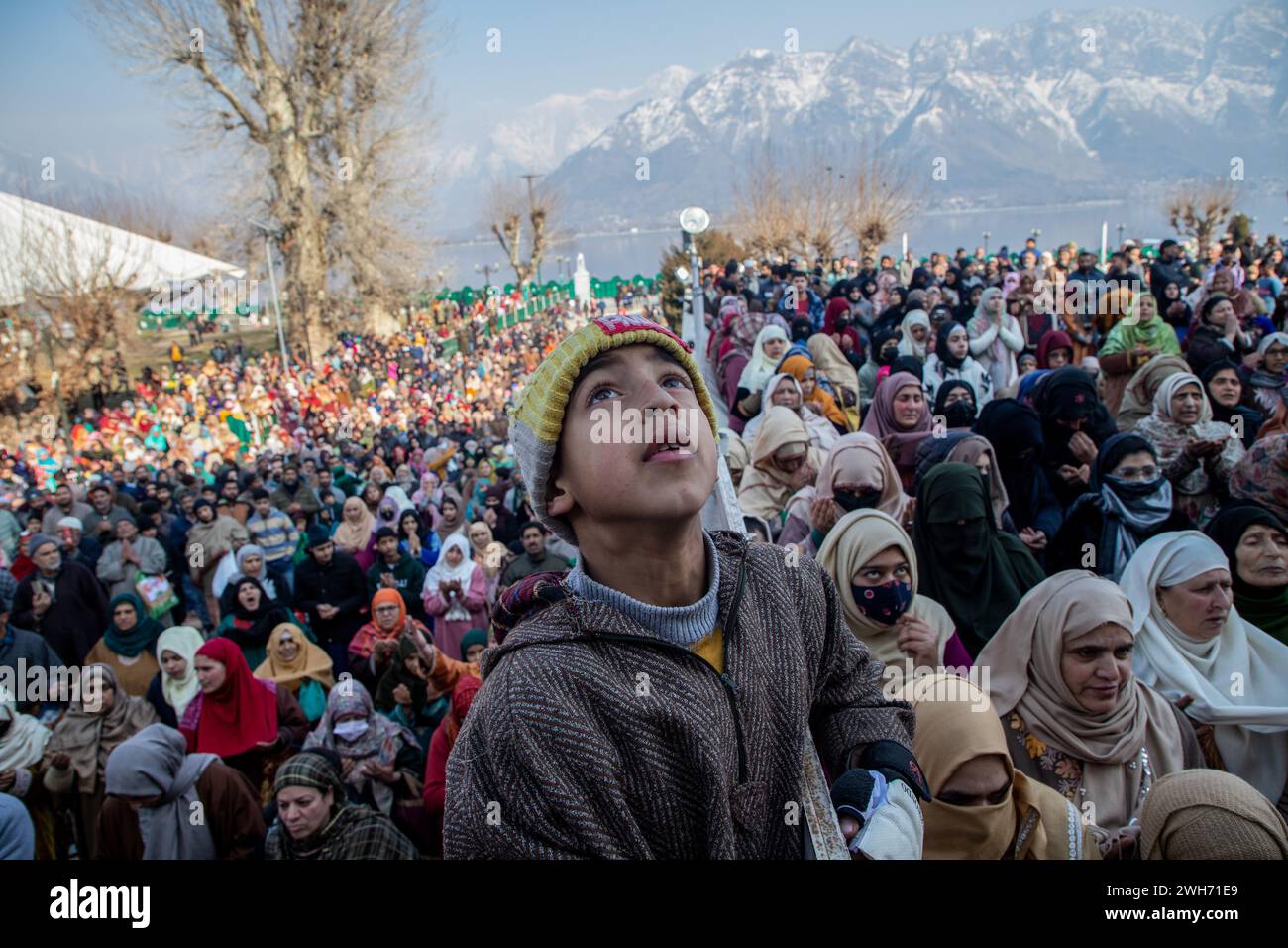 A Muslim boy looks on as the head cleric (unseen) displays the holy ...