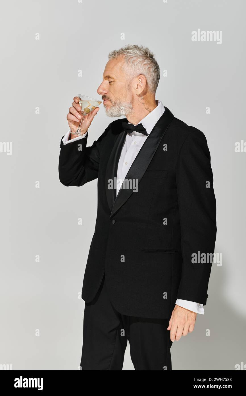 good looking mature man in elegant tuxedo with gray beard and bow tie ...
