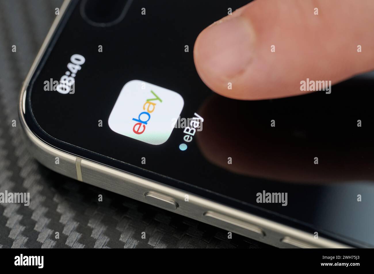 New York, USA - January 24, 2024: Touching top open ebay app icon with ...