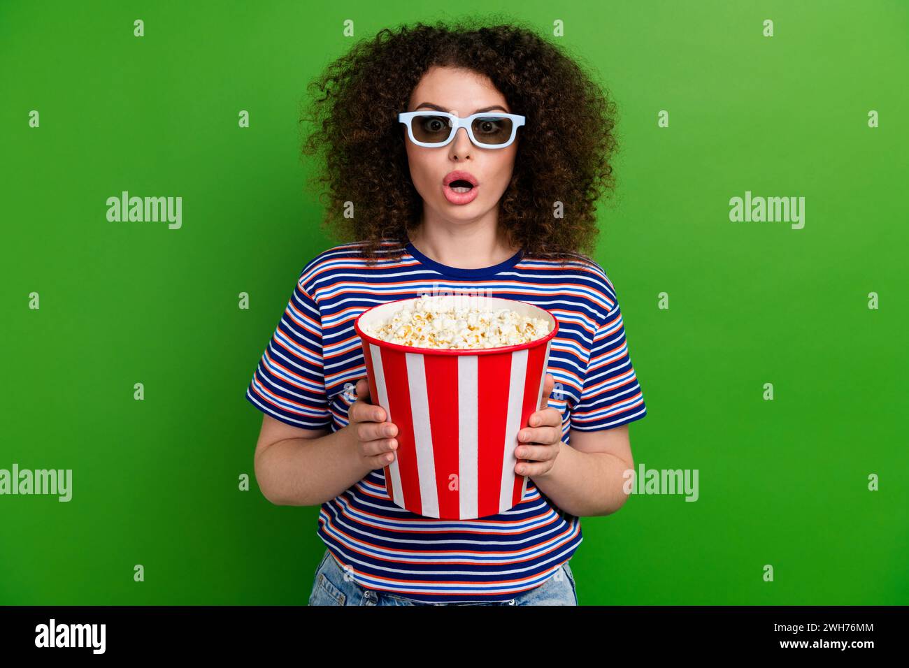 Photo of speechless impressed girl open mouth hold popcorn watch film ...