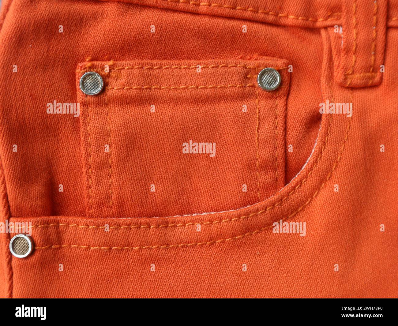 Orange jeans pocket on the right side. Vertical background Stock Photo ...