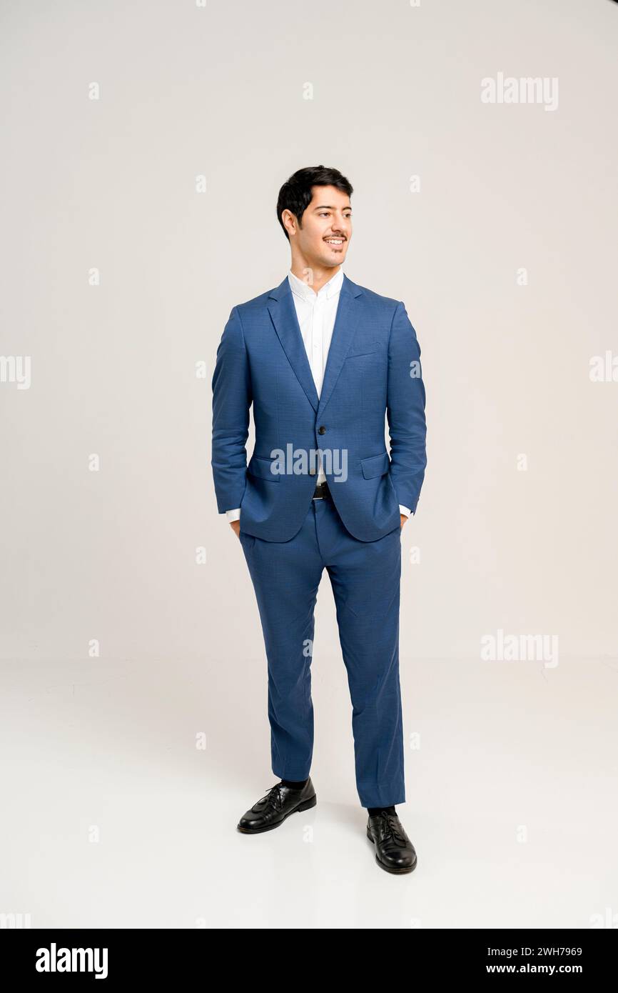 With a profile stance and thoughtful look, the man in blue suit ...