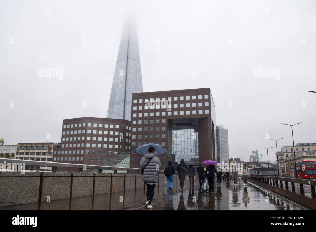 London, UK. 8th February 2024. People walk across London Bridge past a ...