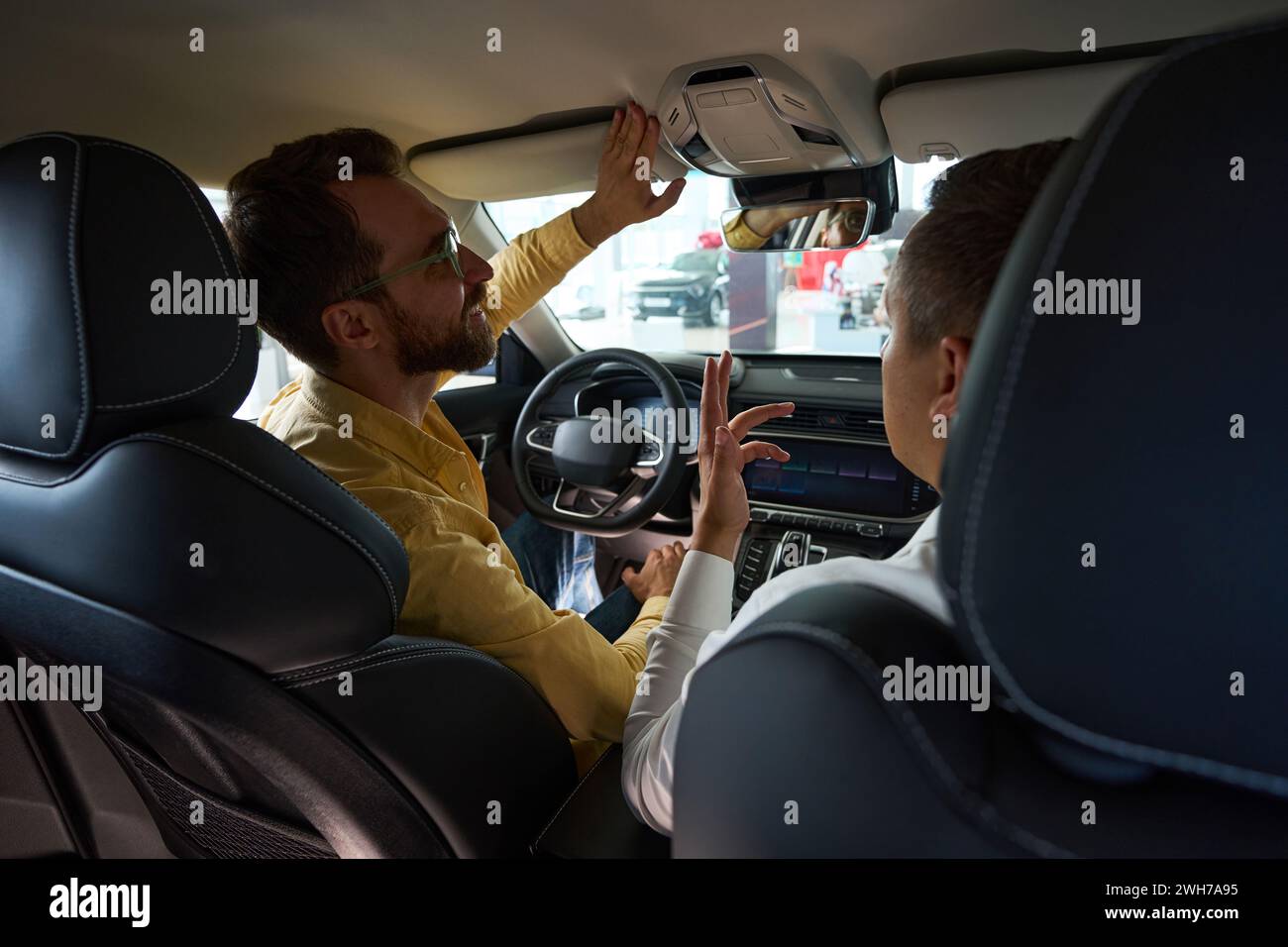 Manager and client are seated in interior of modern car Stock Photo - Alamy