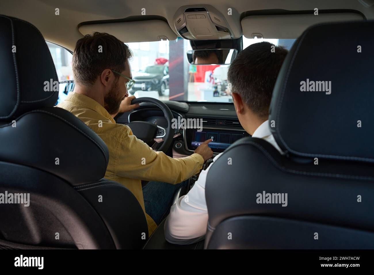 Men sit in the interior of a modern car Stock Photo - Alamy