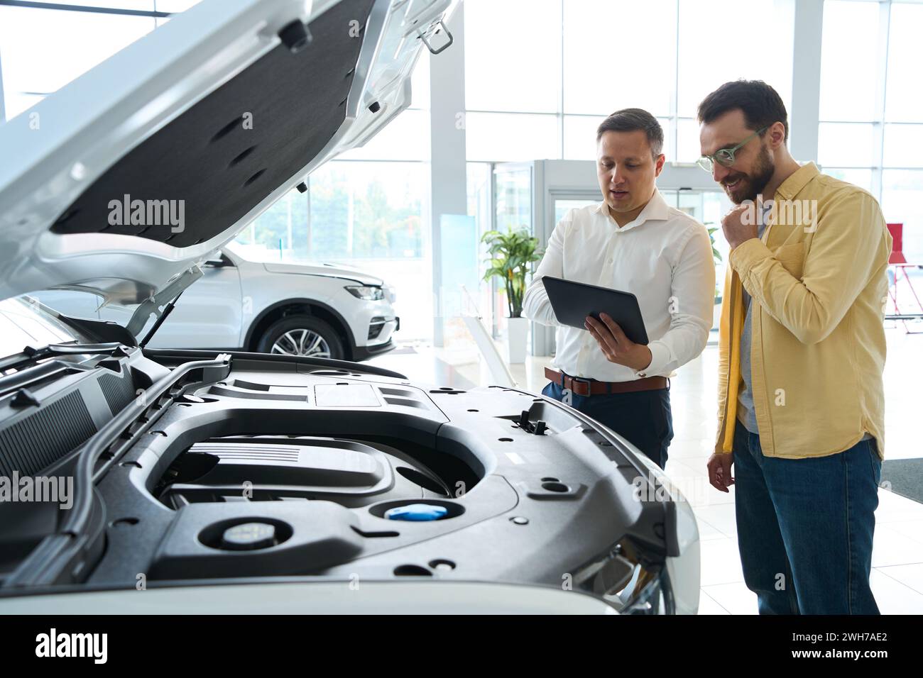 Car dealership manager advises hi-res stock photography and images - Alamy