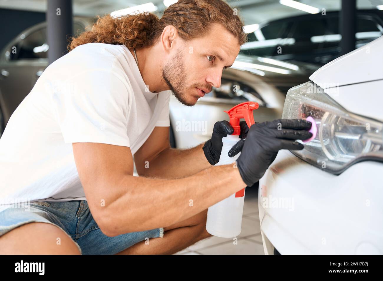 Master uses special clay in car detailing Stock Photo - Alamy