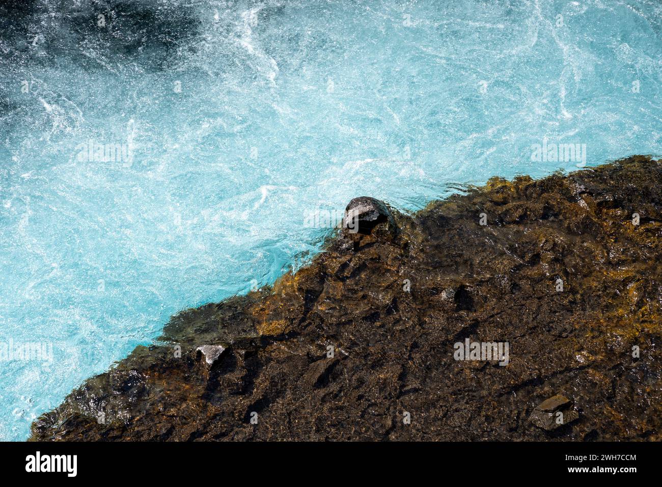 Abstract view of rushing current of the Bruarfoss Waterfall in Iceland ...