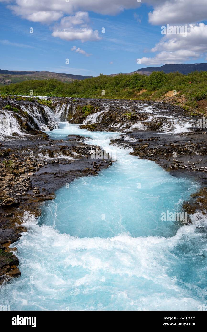 Bruarfoss waterfall on a sunny day in summer. Features beautiful teal ...