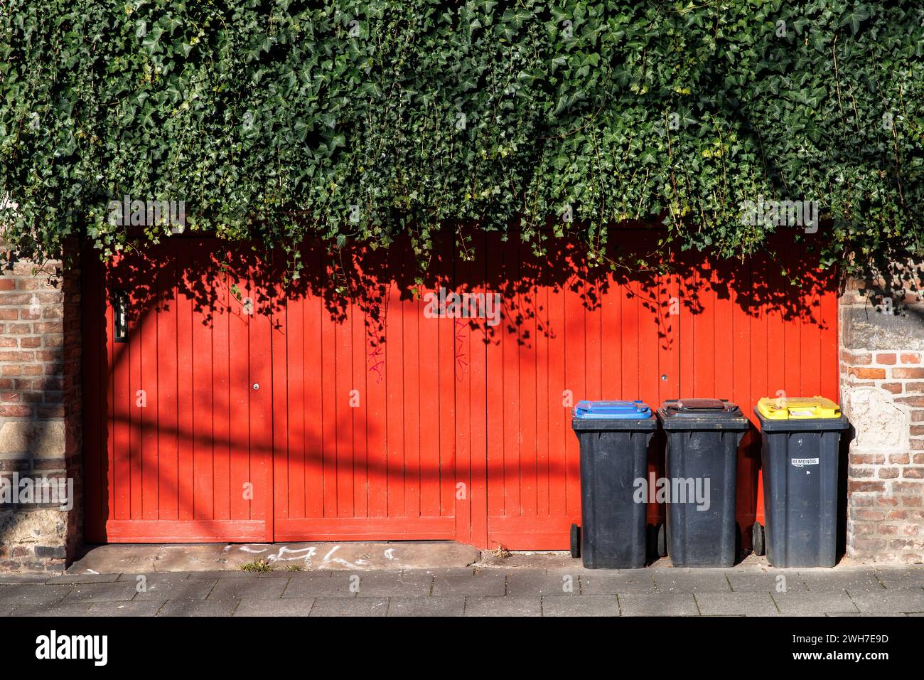 bins in front of a red gate on Gereonswall, waste seperation, Cologne ...