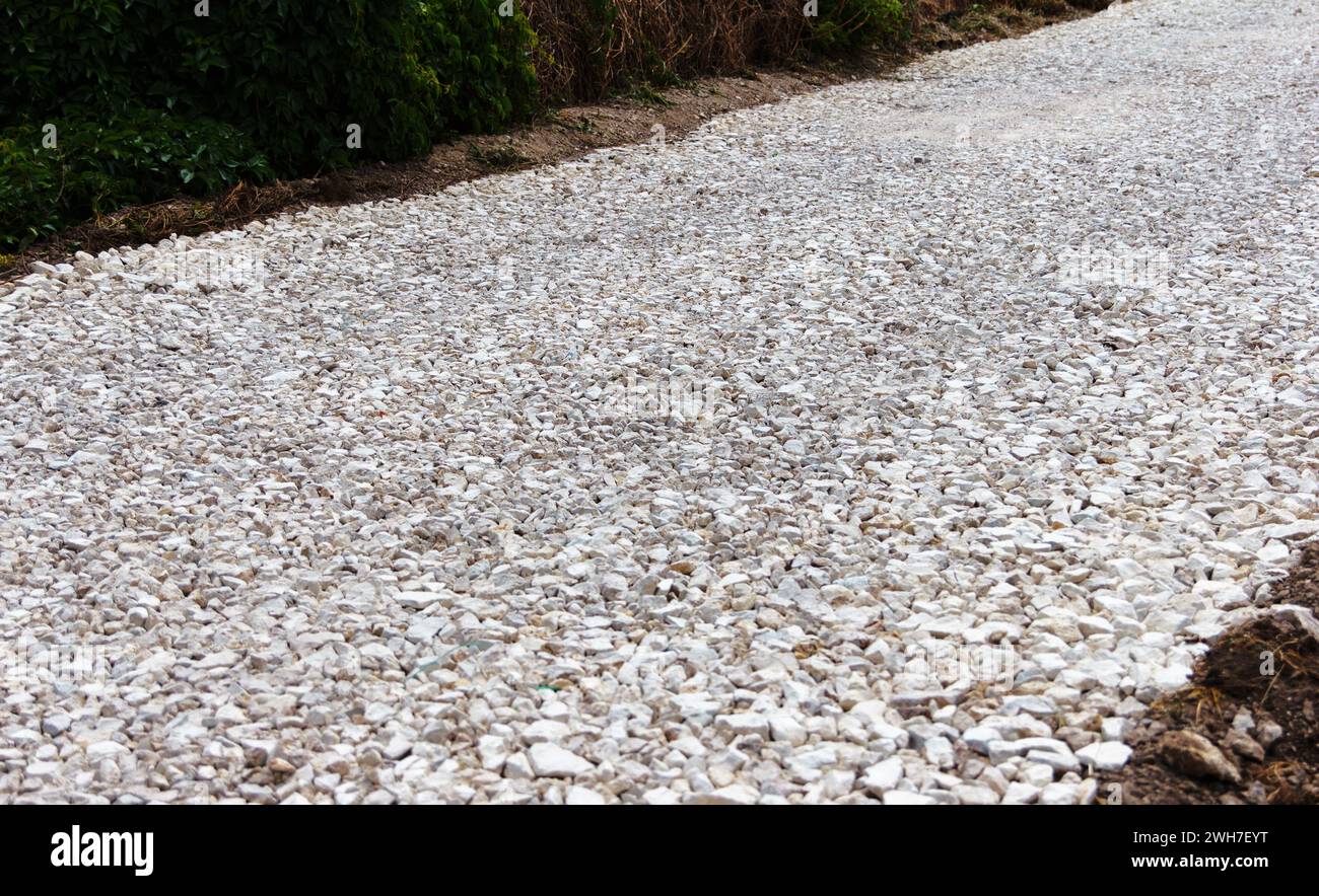 Work is underway to build and lay a new road. Gravel of large fractions ...
