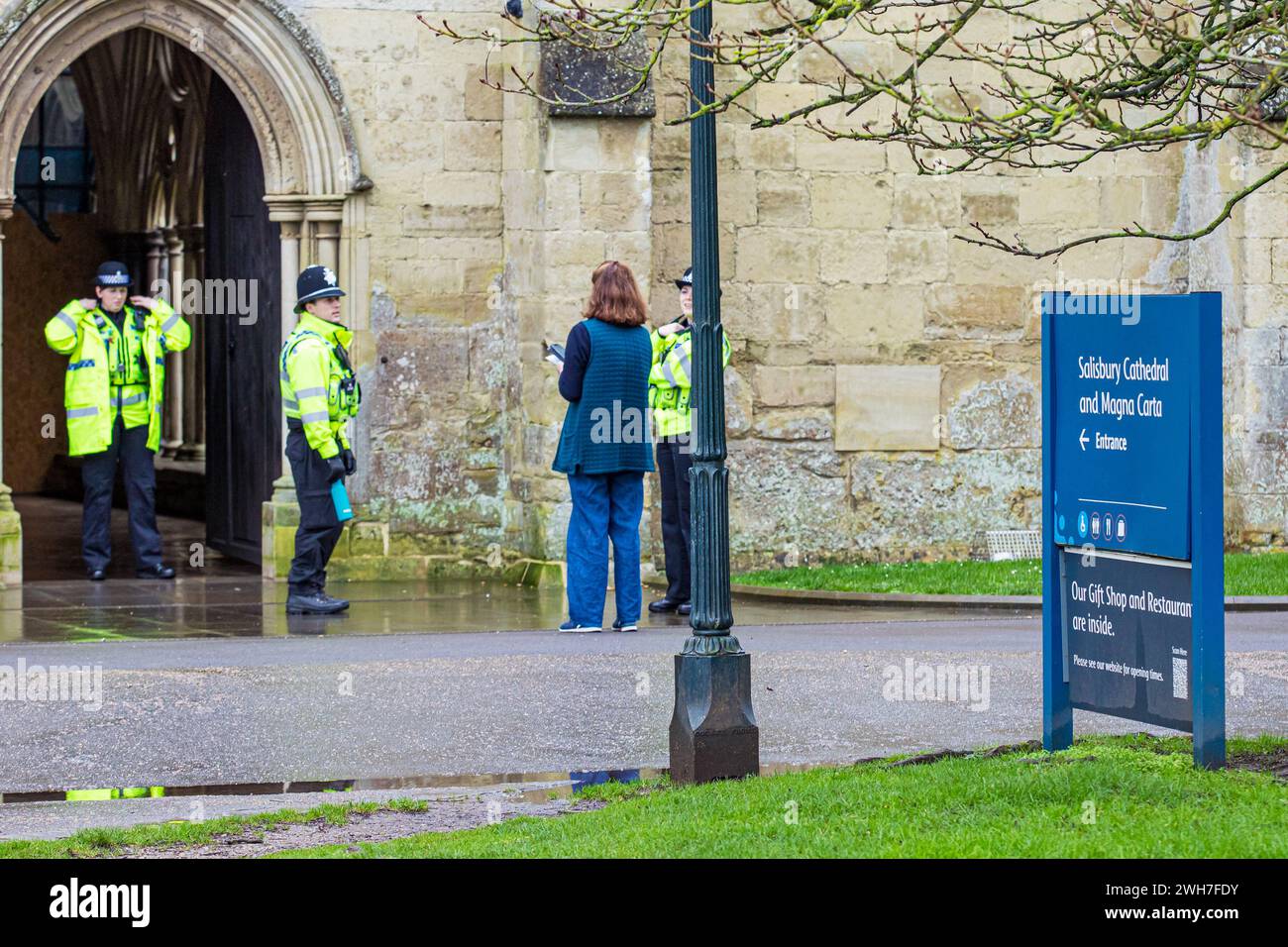 Police officers in yellow jackets interacting with members of the ...