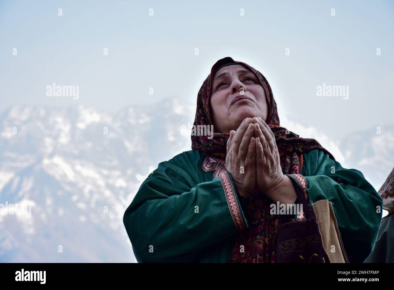 A Muslim devotee prays upon seeing a relic believed to be a hair from ...