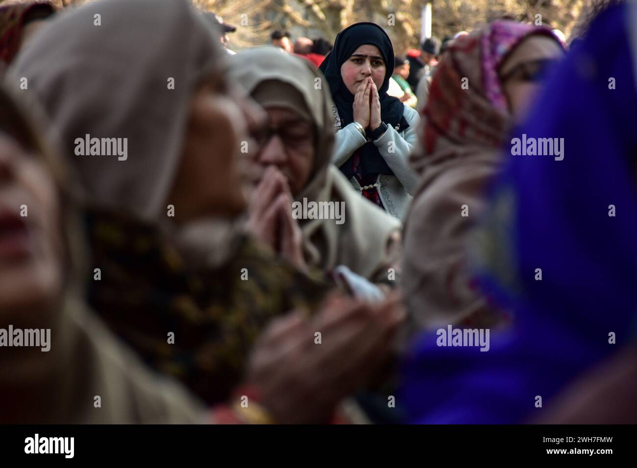 A Muslim devotee prays upon seeing a relic believed to be a hair from ...